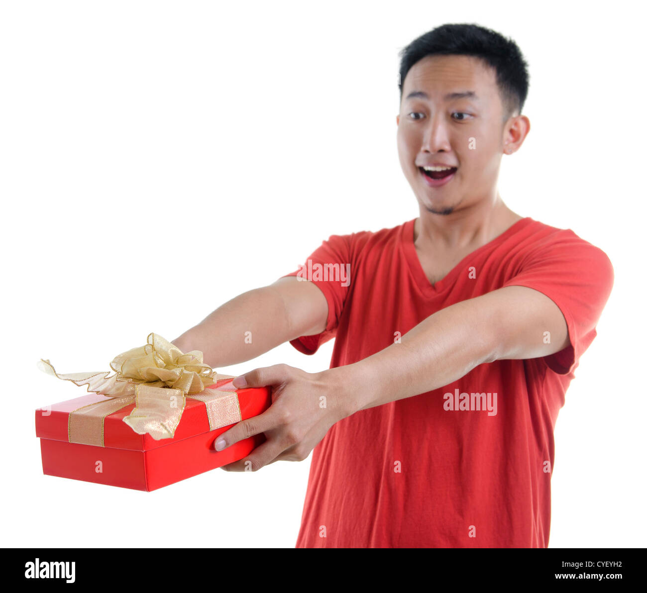 Asian young man giving a gift box on white background Stock Photo - Alamy