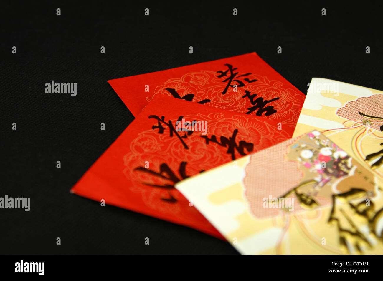Red packets on black background Stock Photo - Alamy