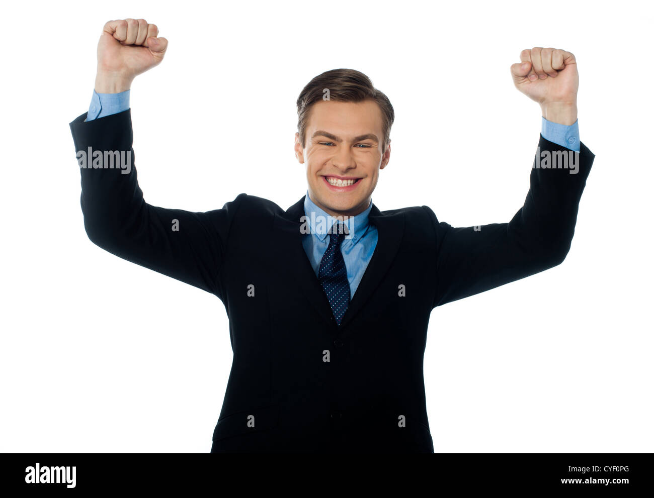 Portrait of confident young businessman celebrating success with arms ...