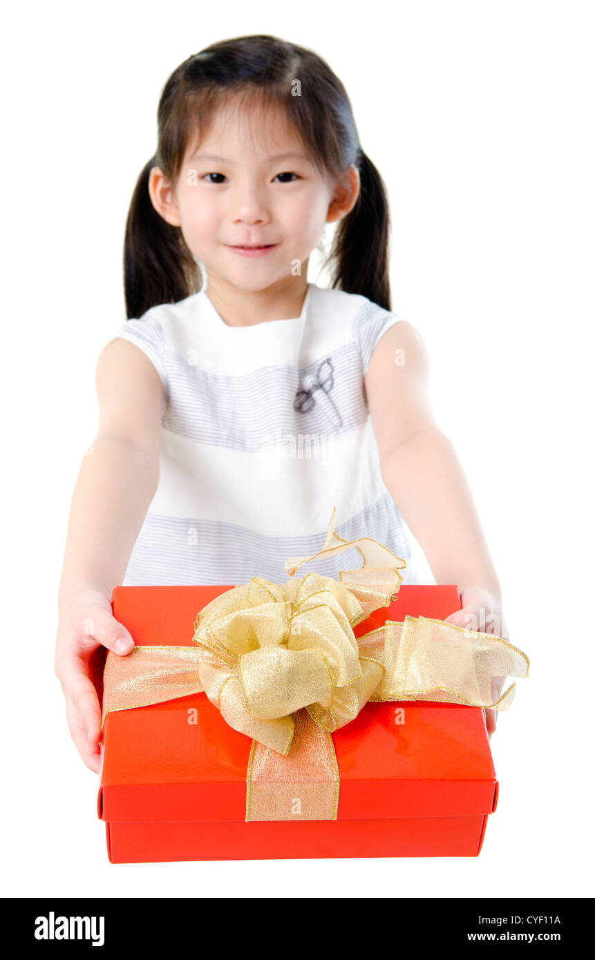 Little Asian girl arms out holding a beautiful wrapped present. Focus ...