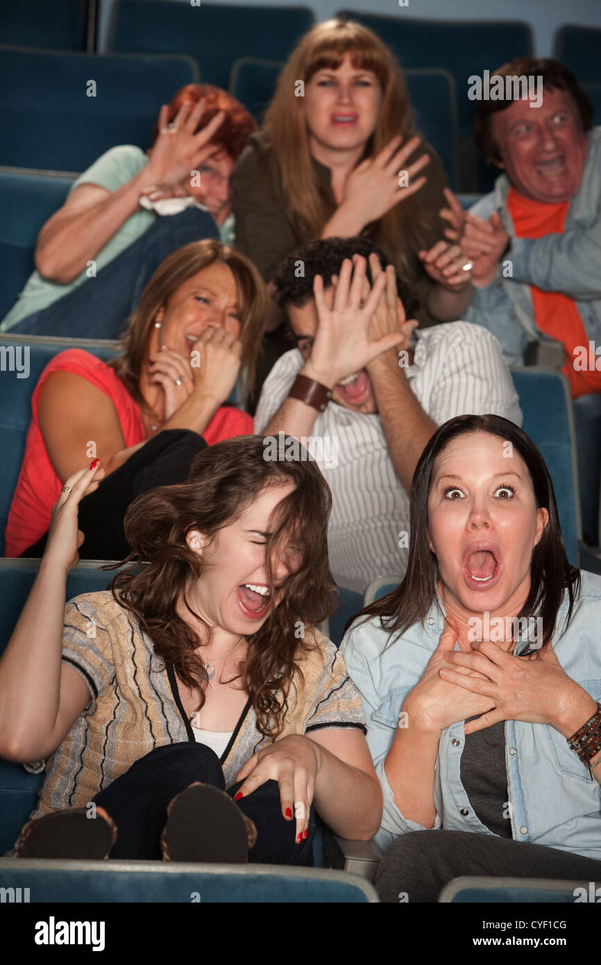 Group of seven scared audience members cringe in their seats Stock ...