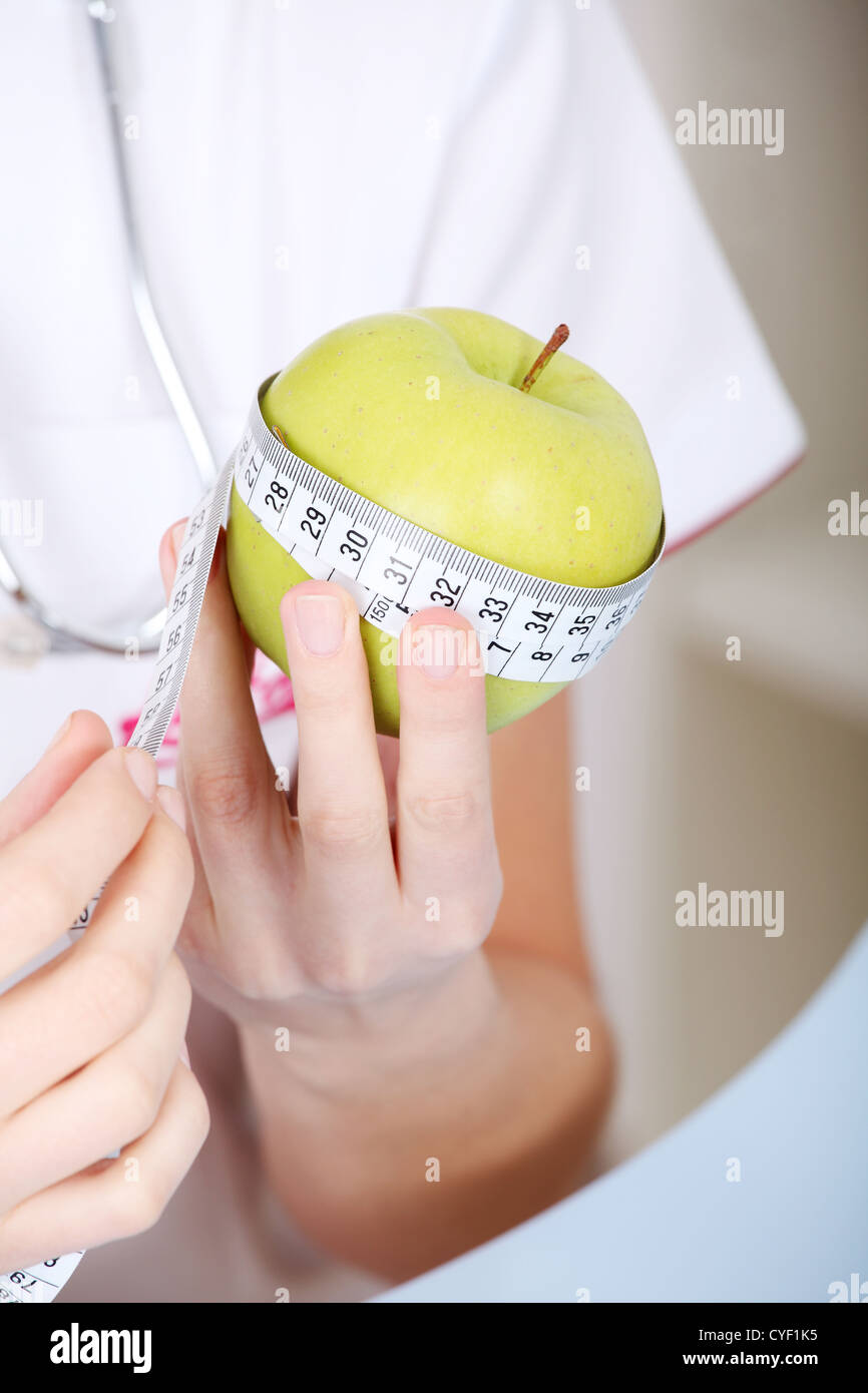 Closeup on measuring apple in caucasian woman`s hands Stock Photo - Alamy