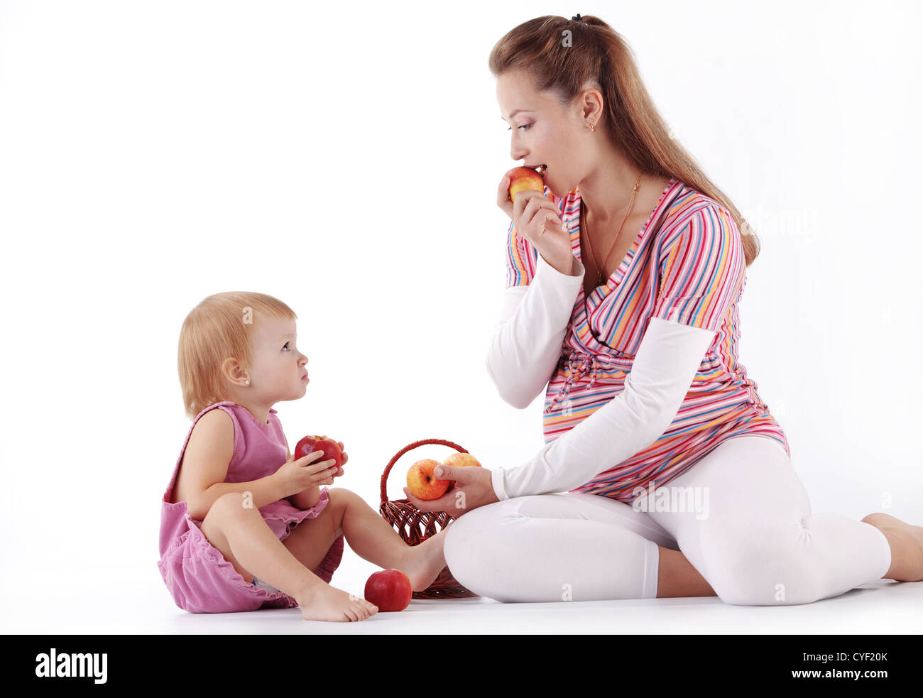 Mother playing with her little daughter studio shot Stock Photo - Alamy