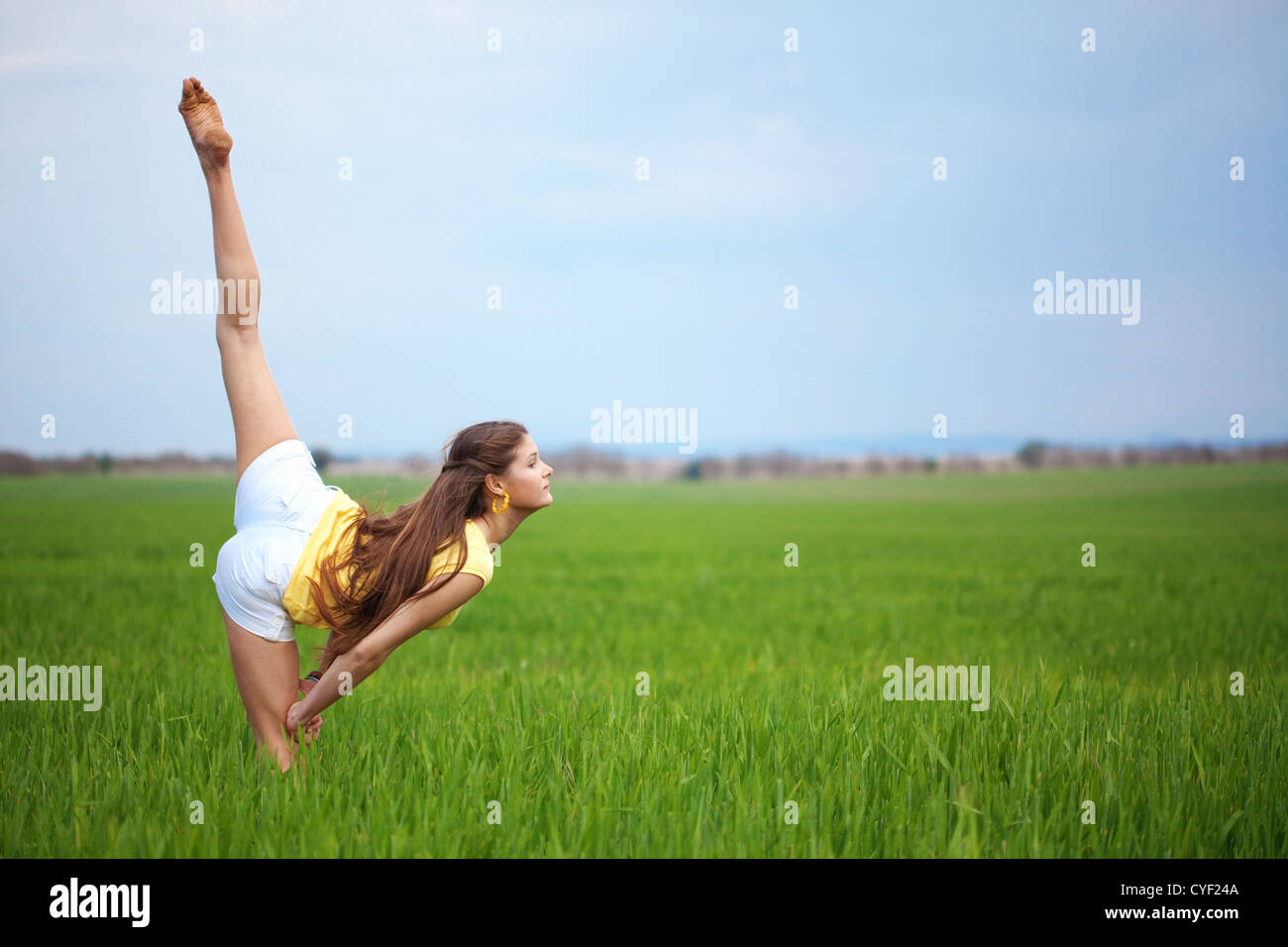 Young beautiful girl doing gymnastic jumps outdoors Stock Photo - Alamy