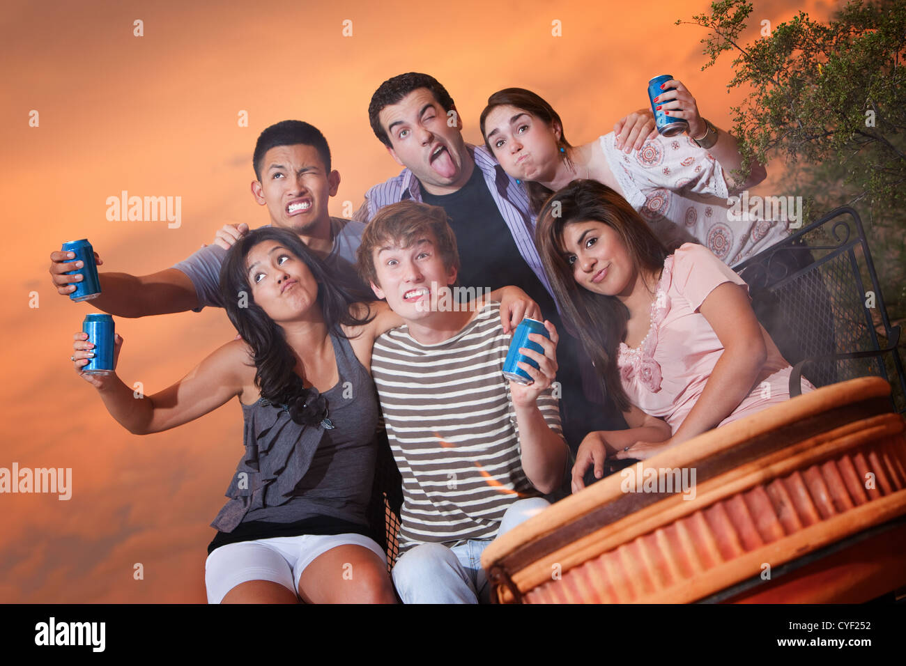 Group of six friends with cans make funny faces Stock Photo - Alamy