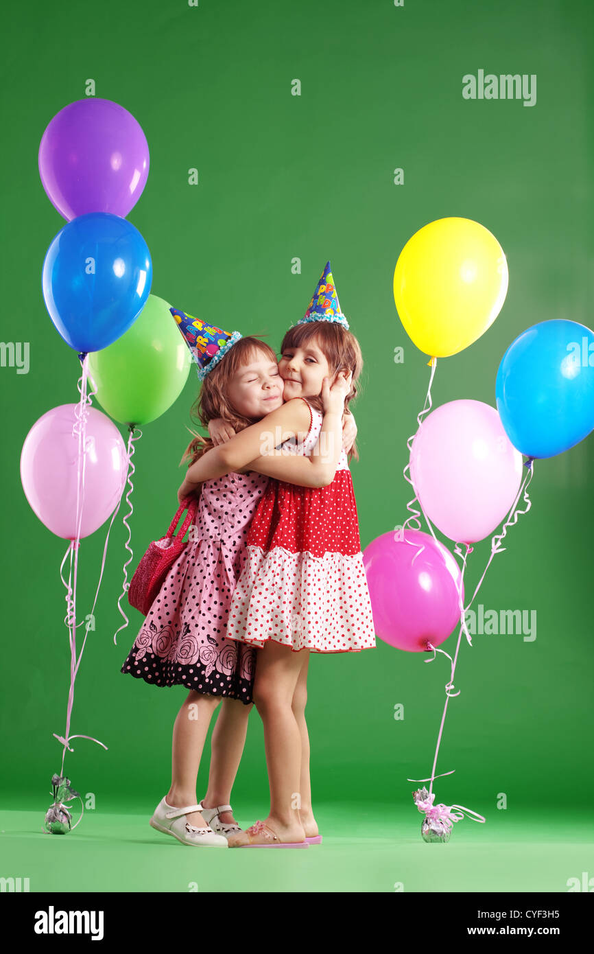 Children celebrating birthday on green studio background Stock Photo ...