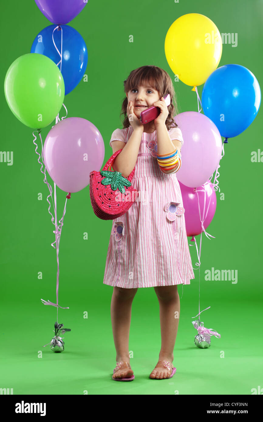 Child celebrating birthday on green studio background Stock Photo - Alamy