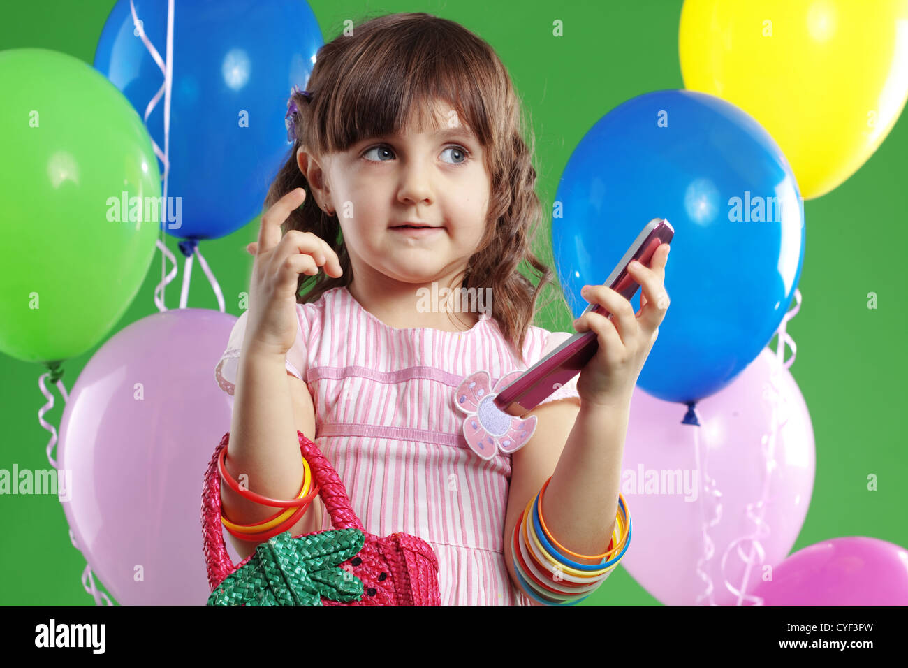 Child celebrating birthday on green studio background Stock Photo - Alamy