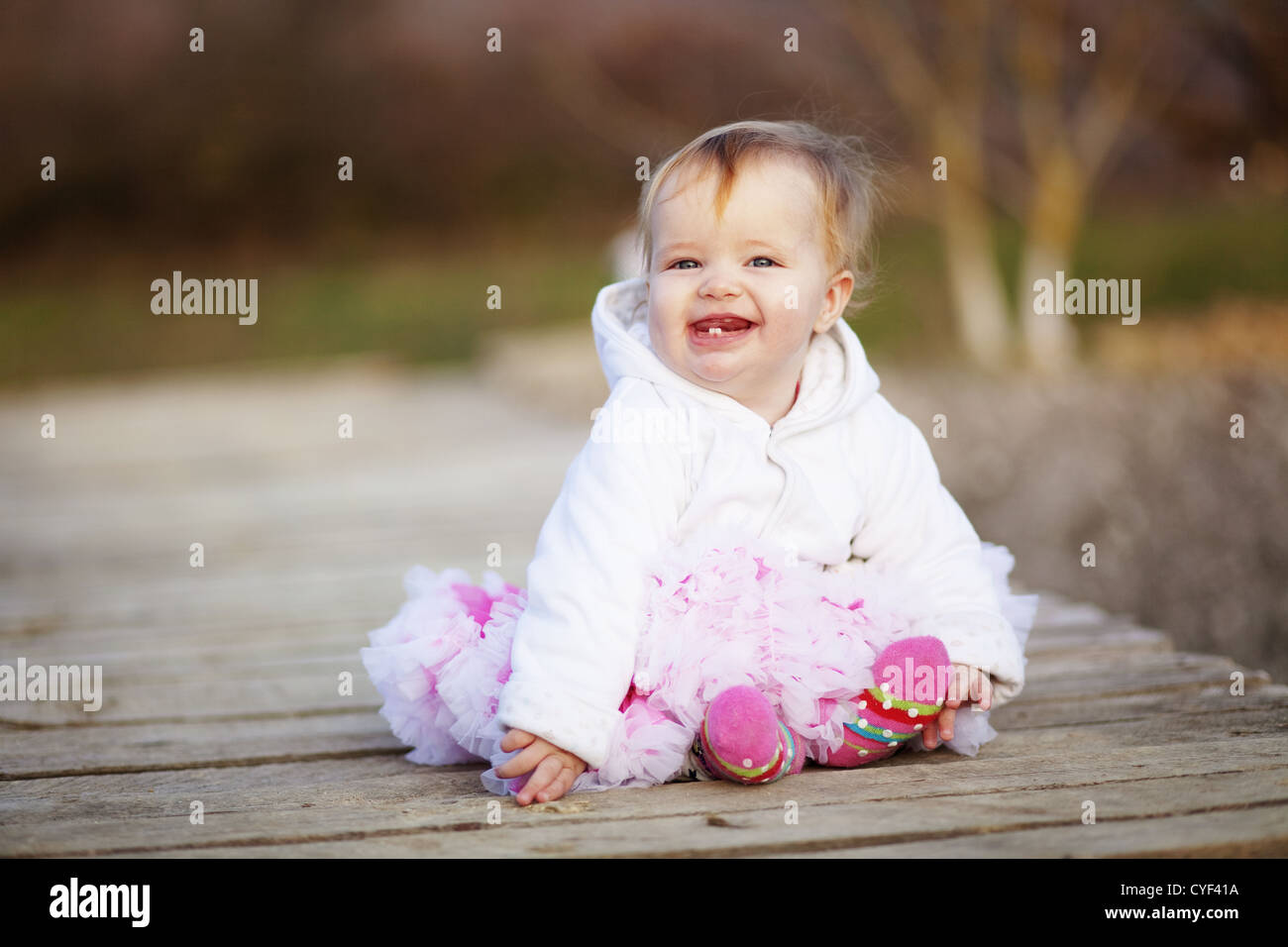 Adorable baby on wooden bridge Stock Photo - Alamy