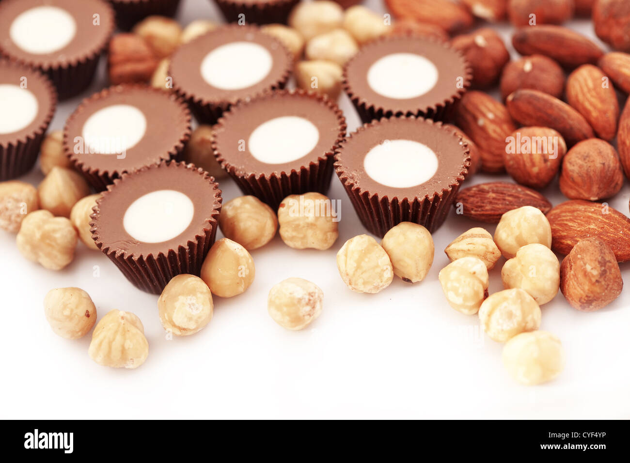 Milk and white chocolate pralines and nuts Stock Photo - Alamy