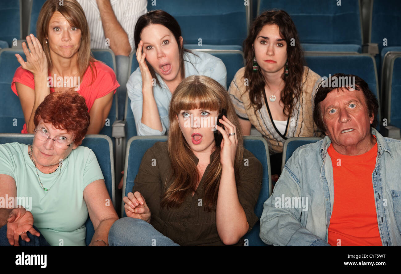 Loud woman on phone annoys audience in theater Stock Photo - Alamy