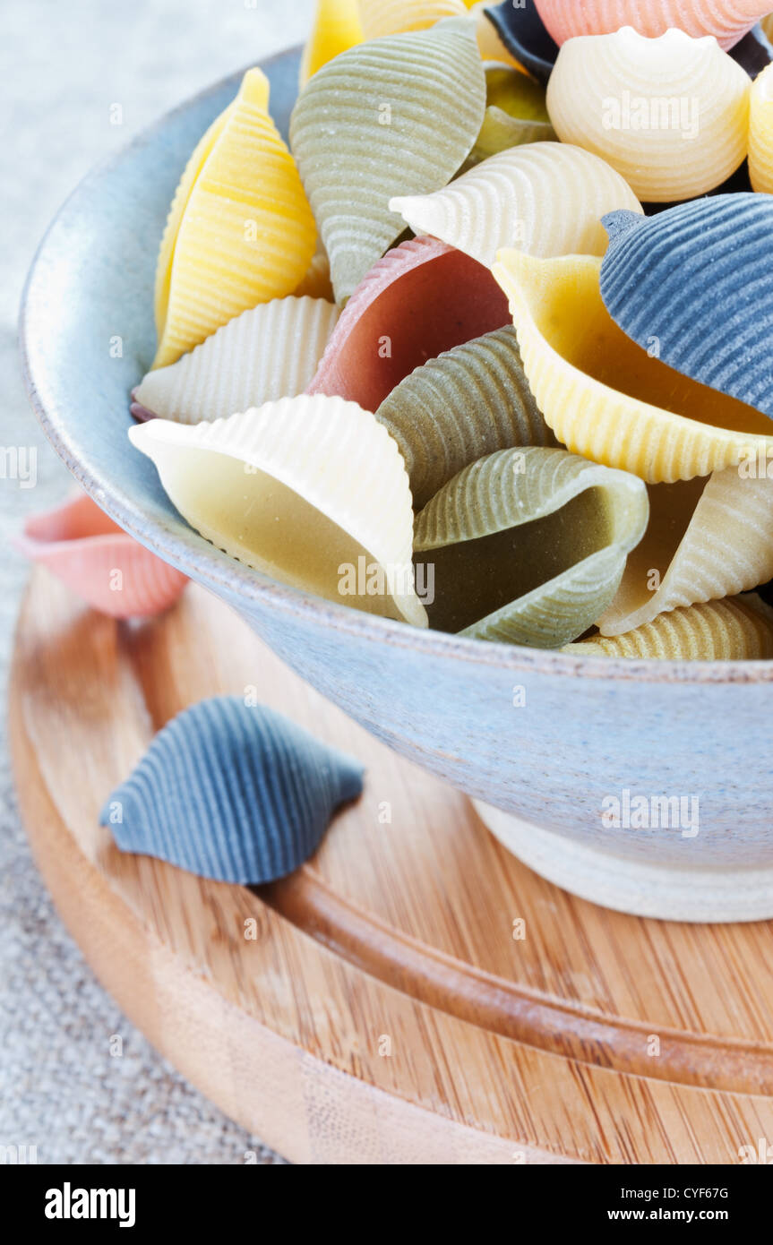 Pasta in bowl on a wooden board close up Stock Photo - Alamy