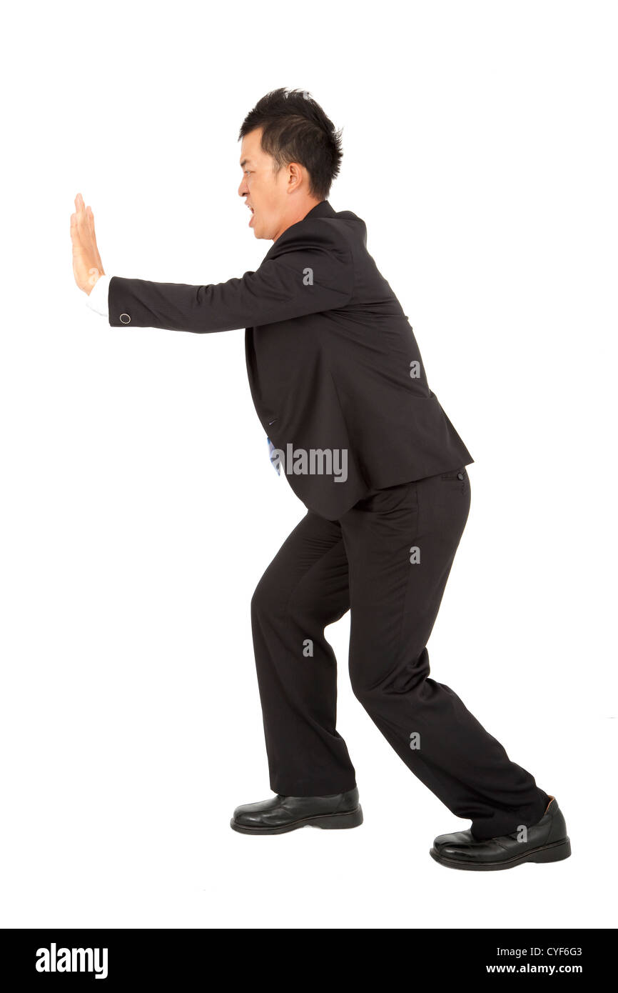 Businessman pushing away the wall Stock Photo - Alamy