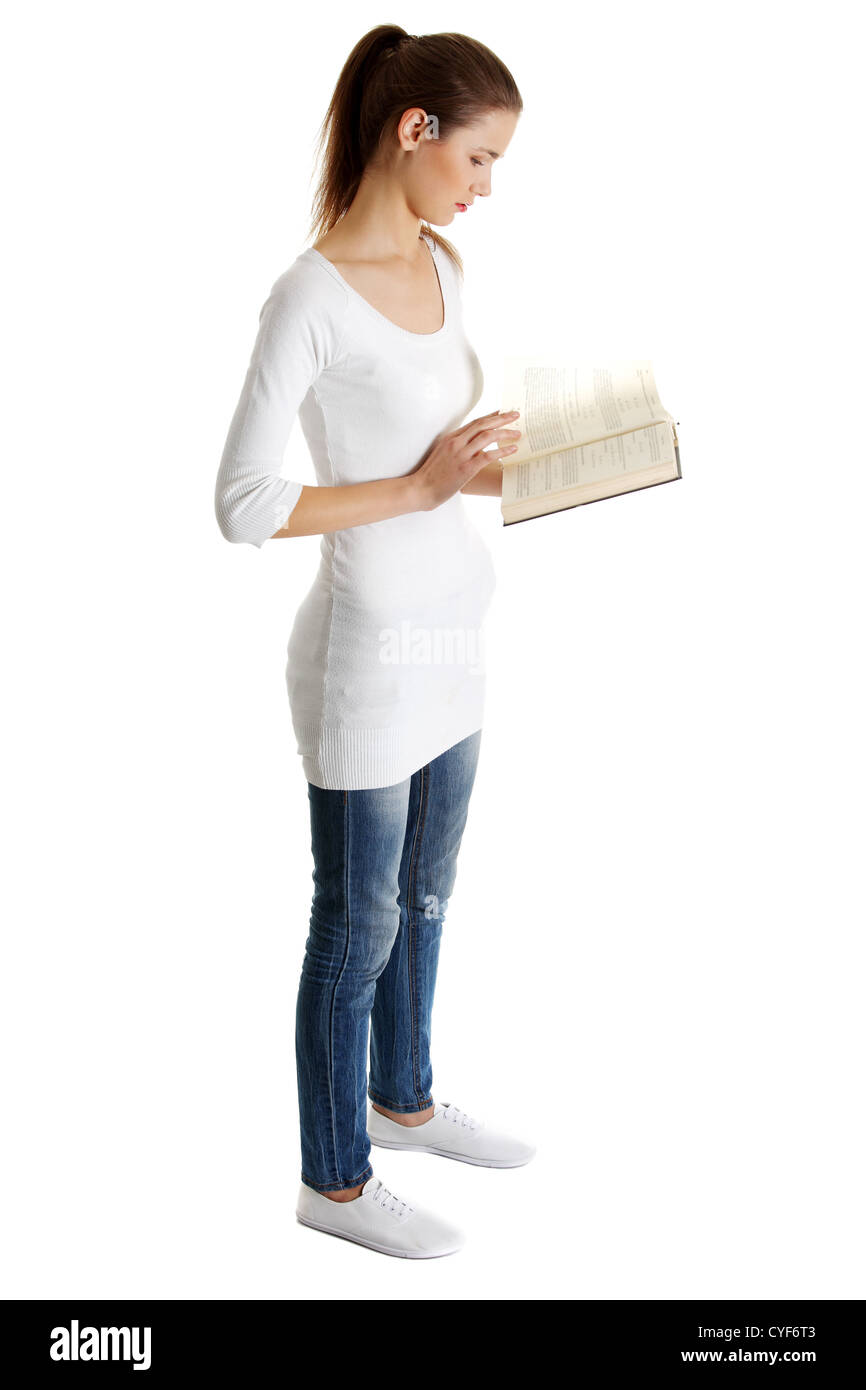 Full lenght portrait of a beautiful young caucasian teen reading a ...