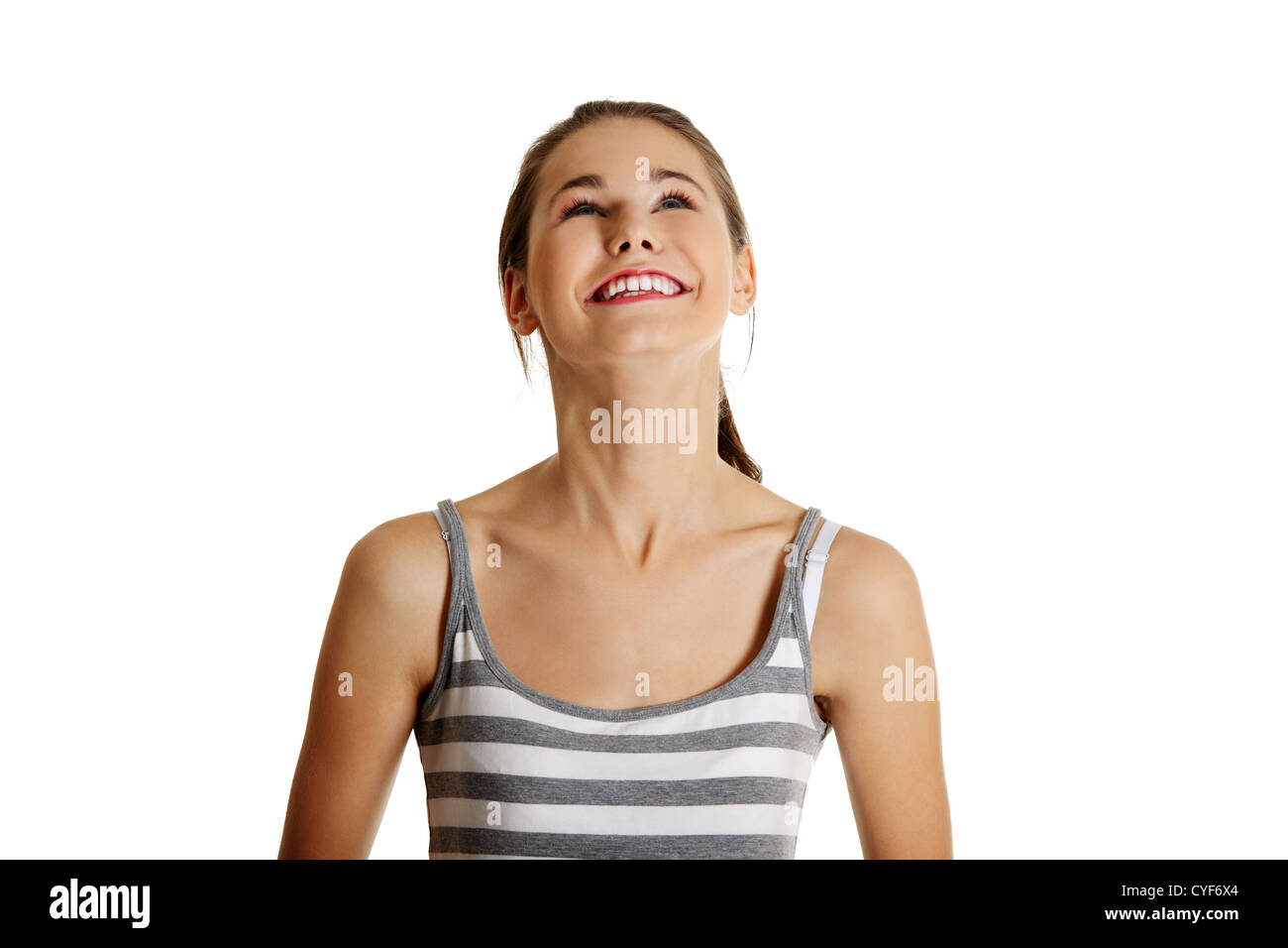 Front view portrait of a smiling young female caucasian teen looking up ...