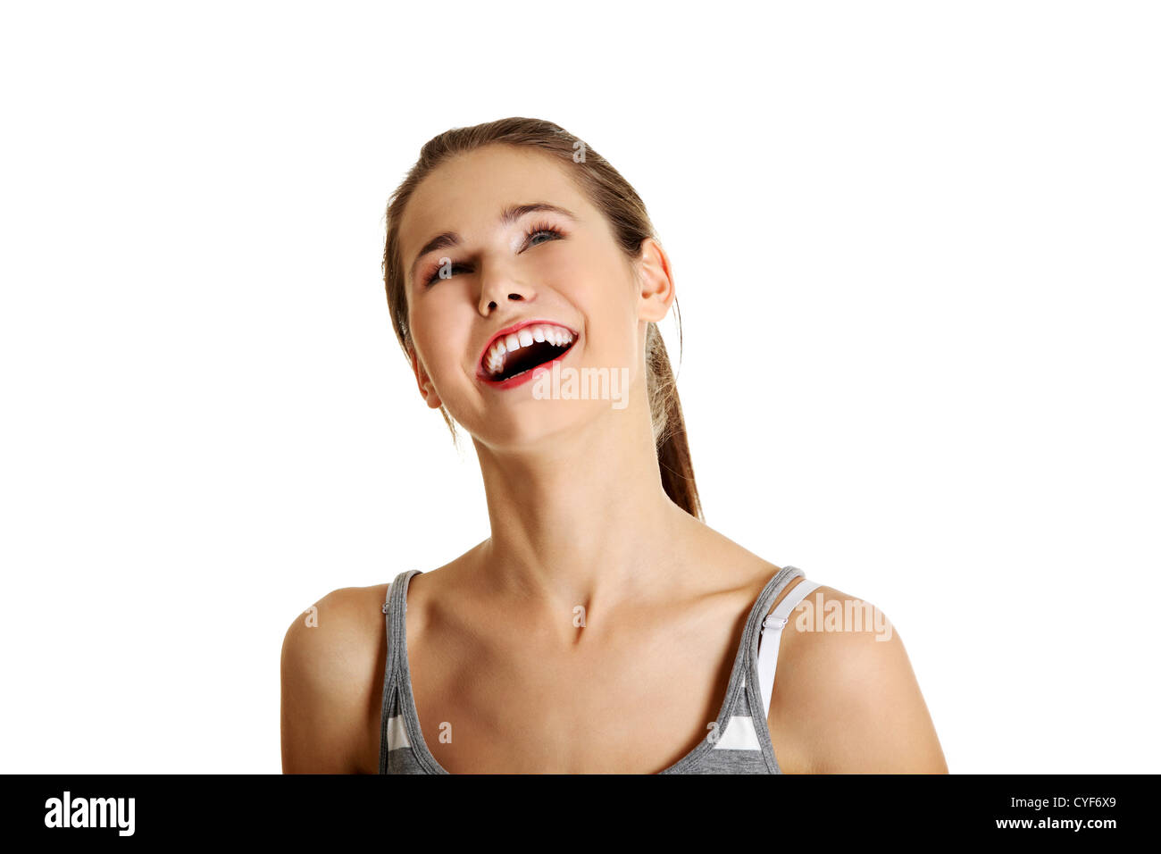Front view portrait of a smiling young female caucasian teen looking up ...
