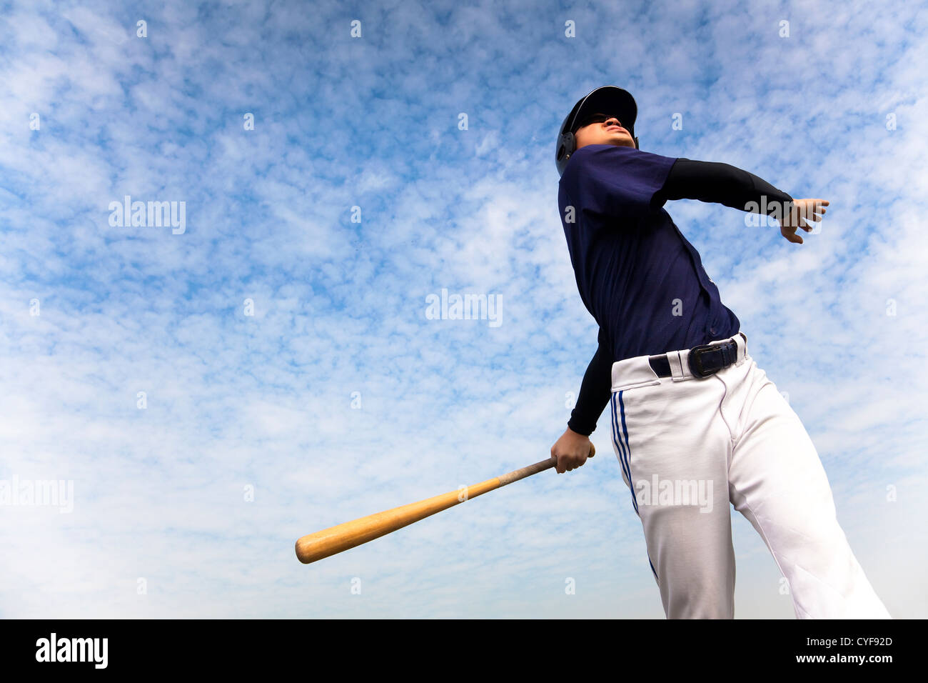 baseball player taking a swing with cloud background Stock Photo - Alamy