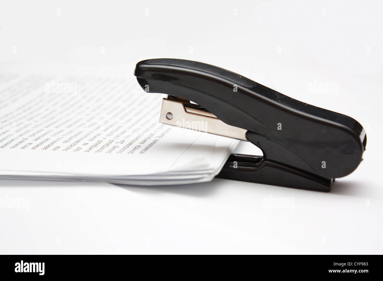 stepler fasten paper on white background Stock Photo - Alamy