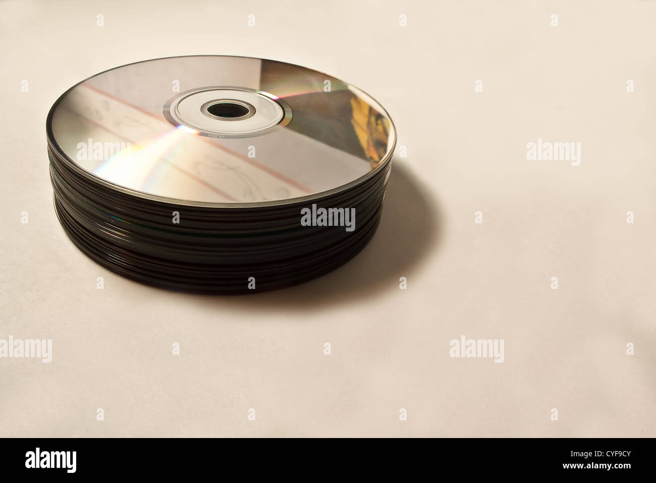 Heap of CD on isolated background with tints of yellow Stock Photo - Alamy