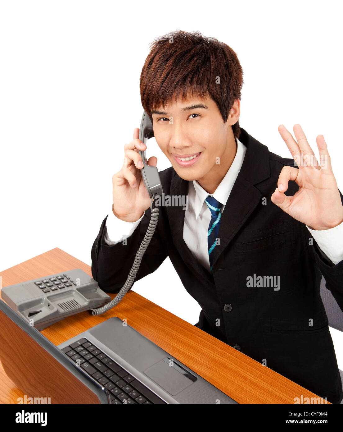 Young businessman holding phone with OK hand gesture Stock Photo - Alamy