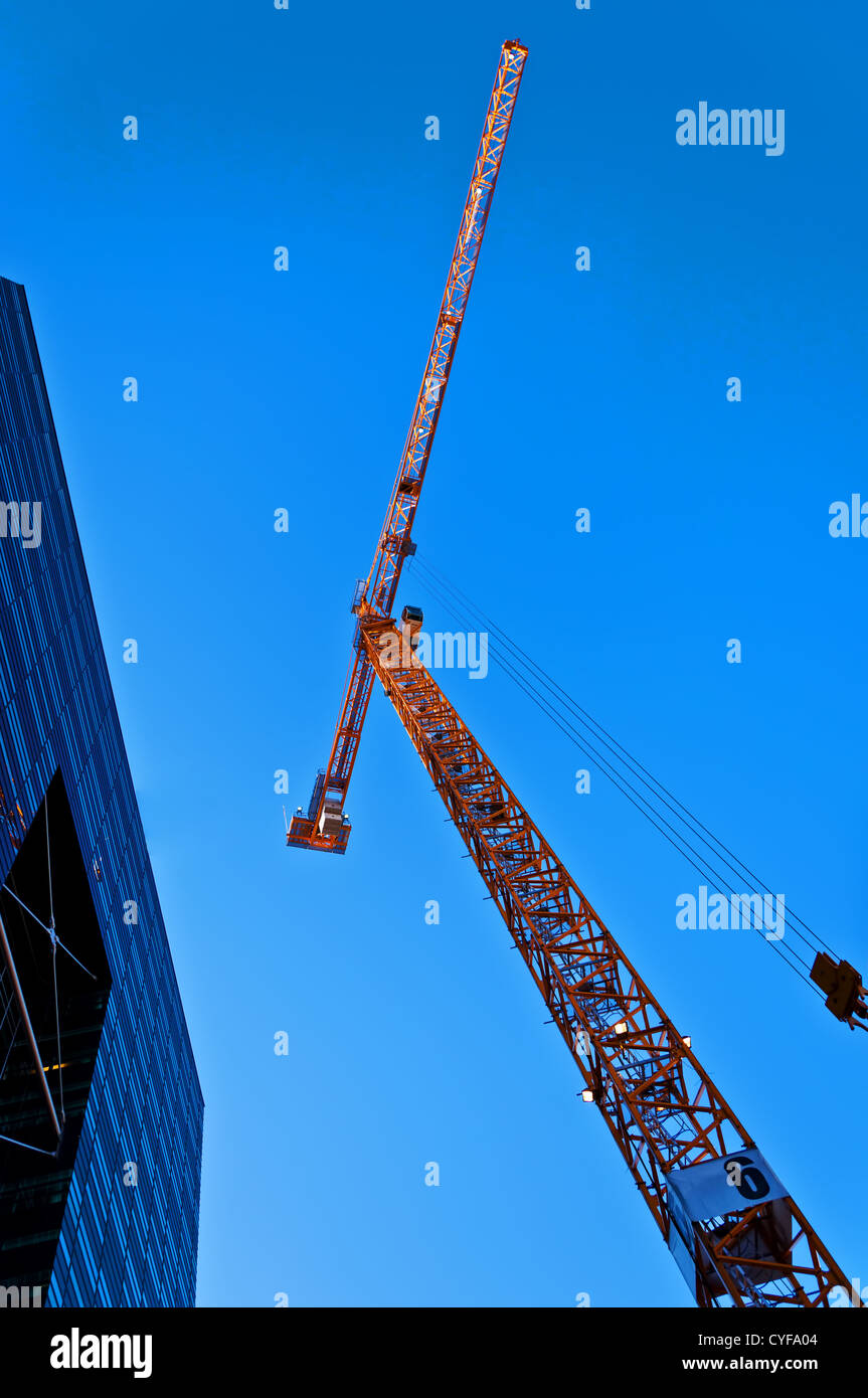 Skyscraper with tower crane on sky background Stock Photo - Alamy