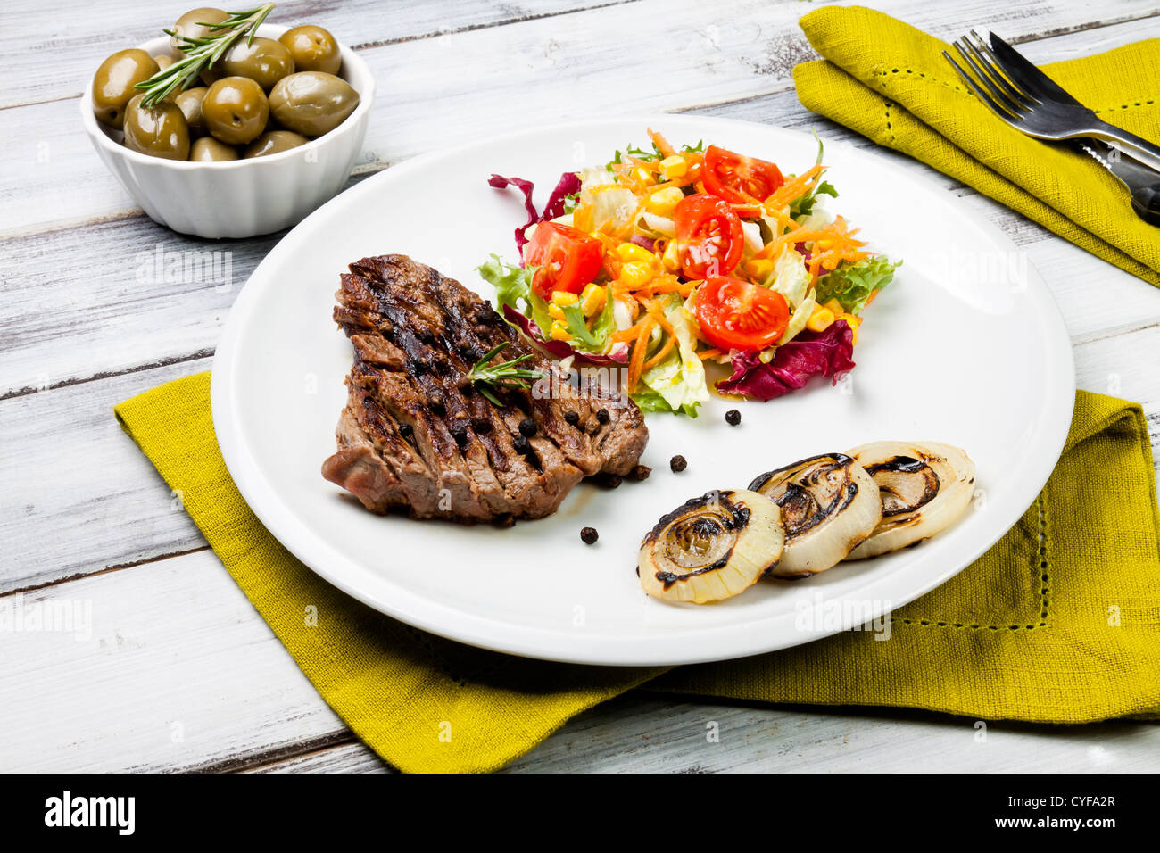 cooked cut of meat garnish with mixed salad Stock Photo - Alamy