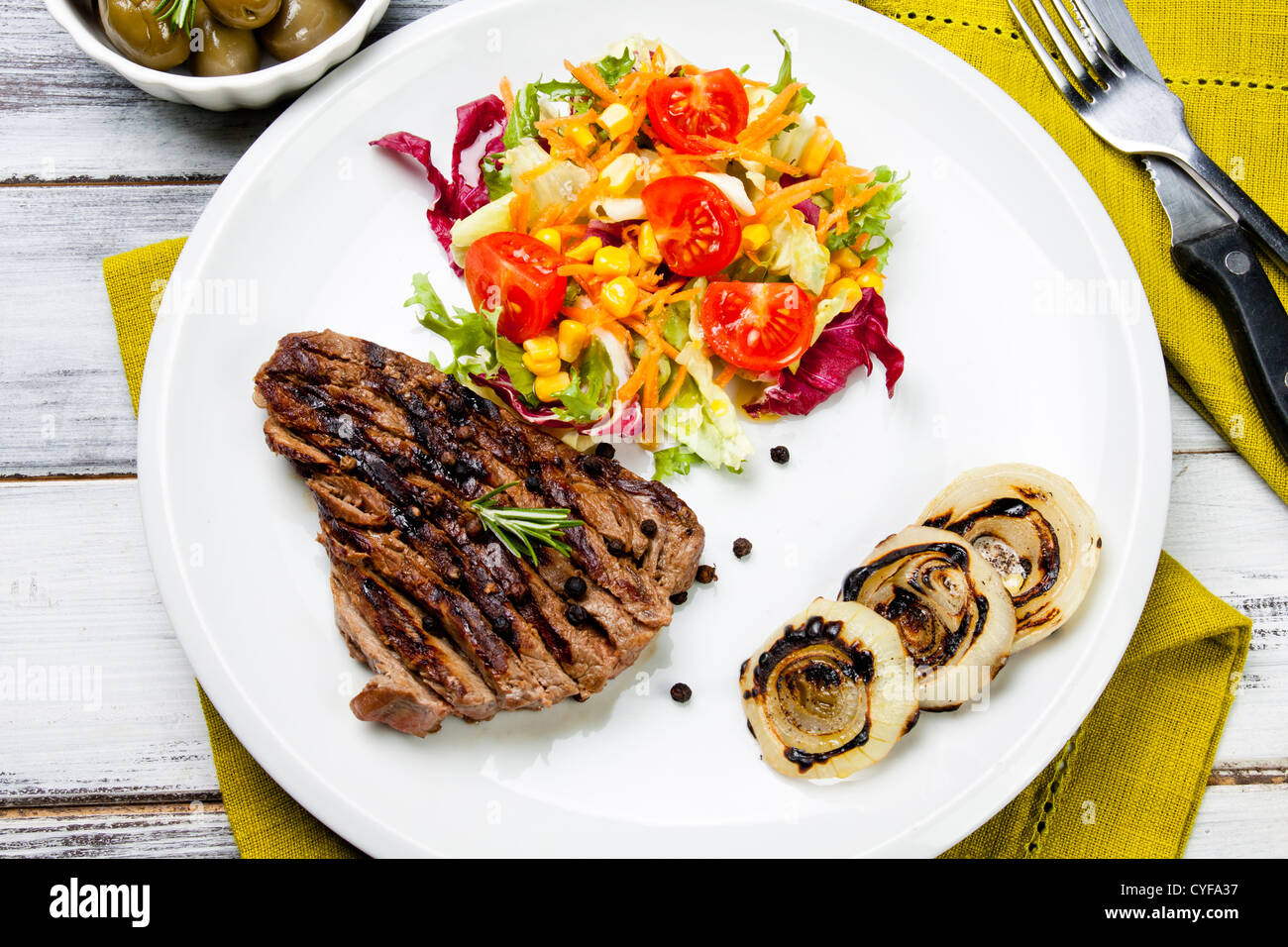 cooked cut of meat garnish with mixed salad Stock Photo - Alamy