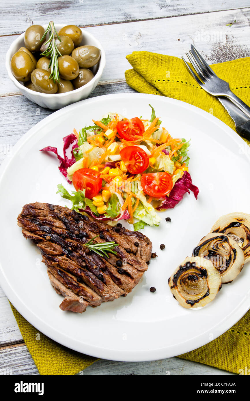 cooked cut of meat garnish with mixed salad Stock Photo - Alamy