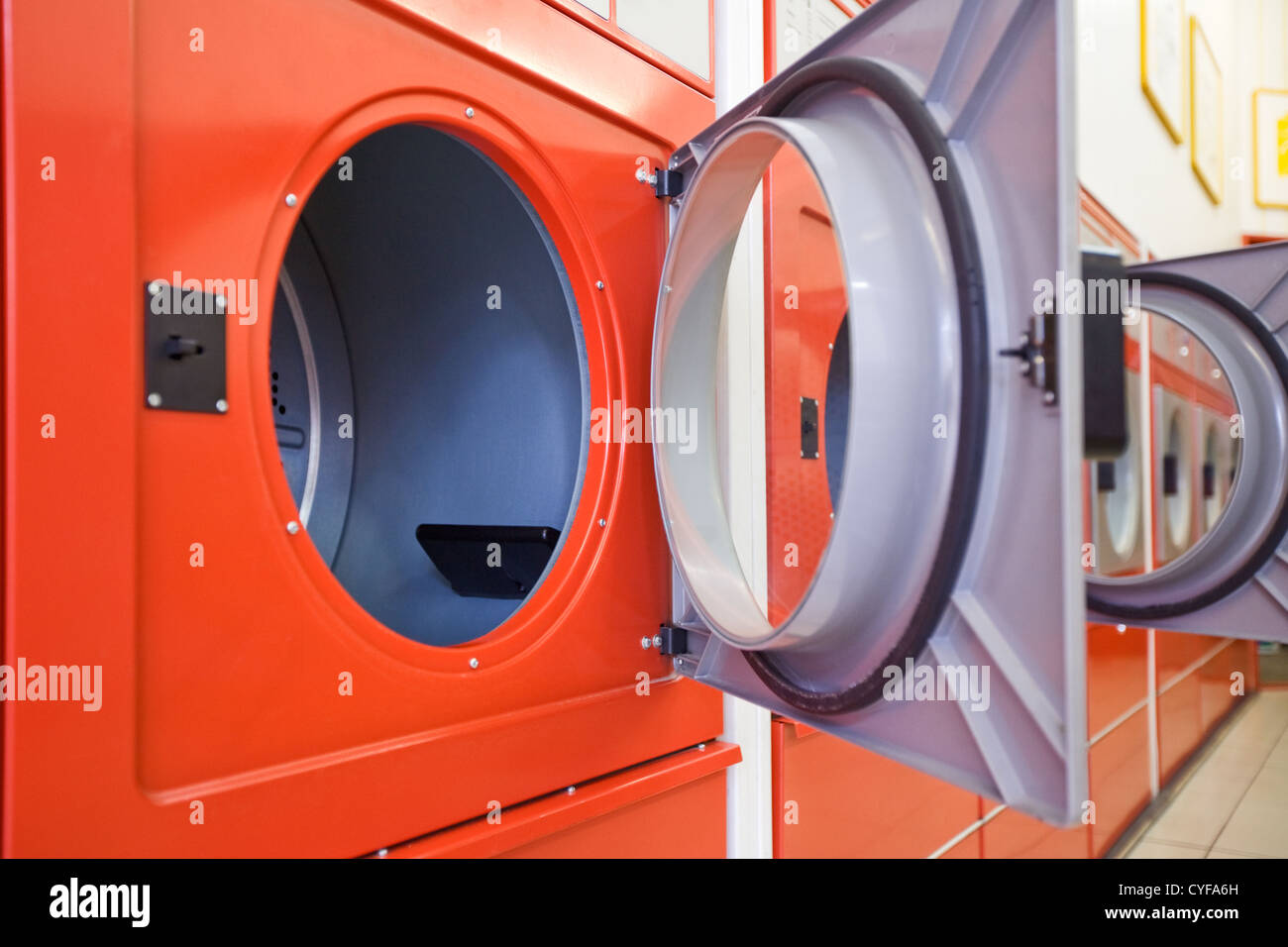 Empty open clothes dryers in a row at public laundromat Stock Photo - Alamy