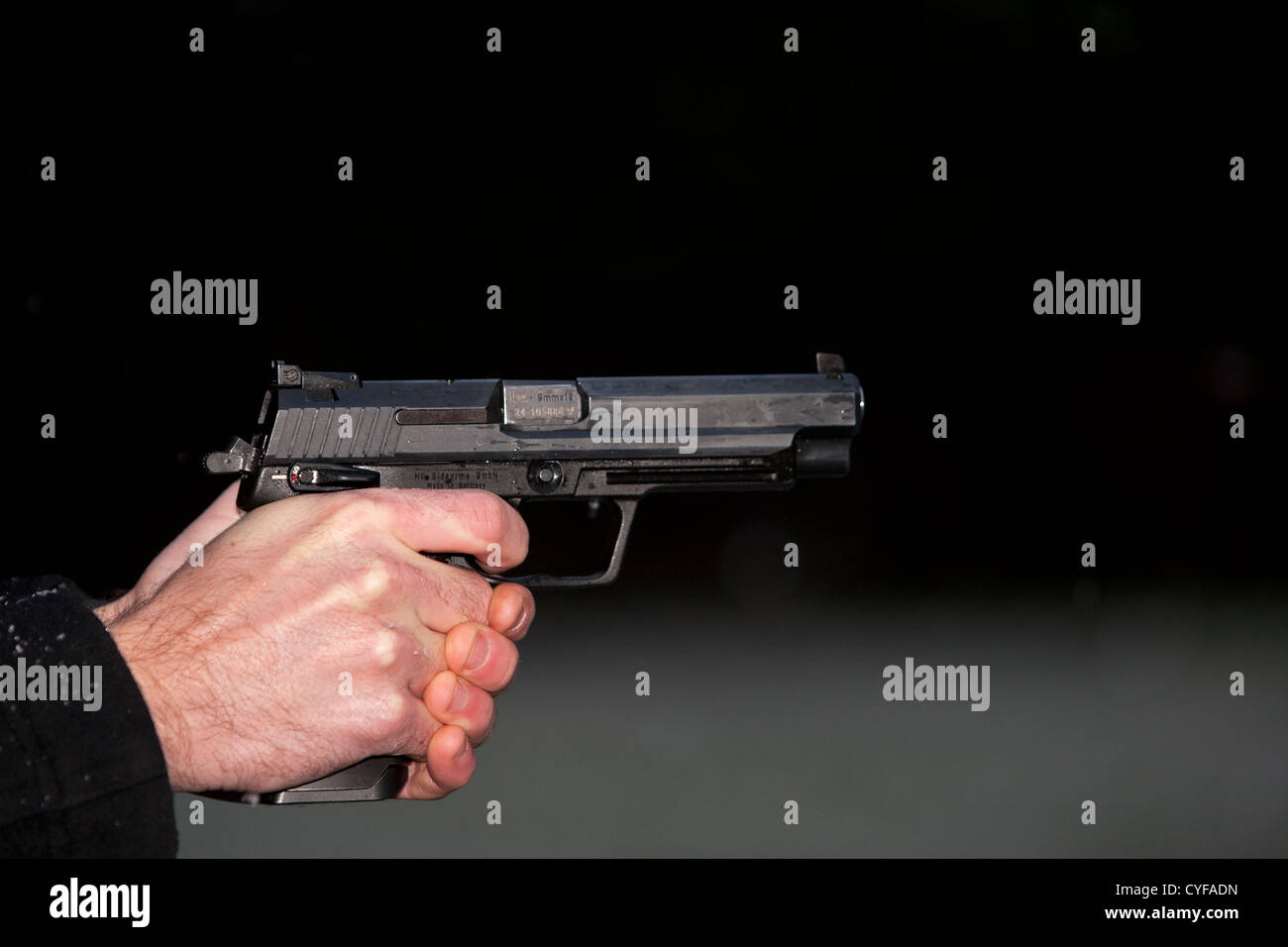 Shoots with gun close up Stock Photo - Alamy