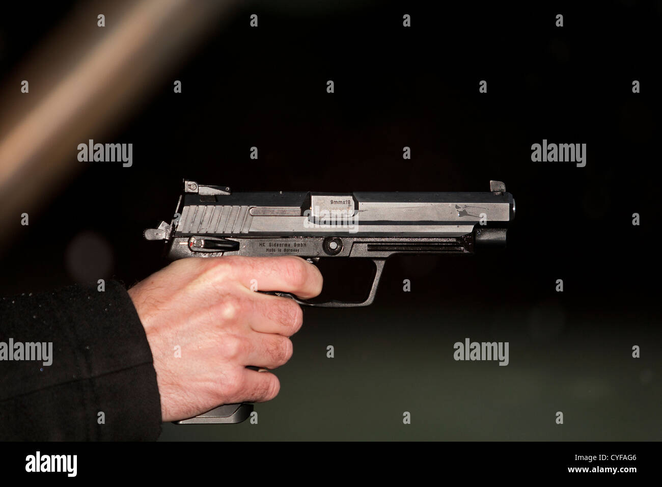 Shoots with gun close up Stock Photo - Alamy