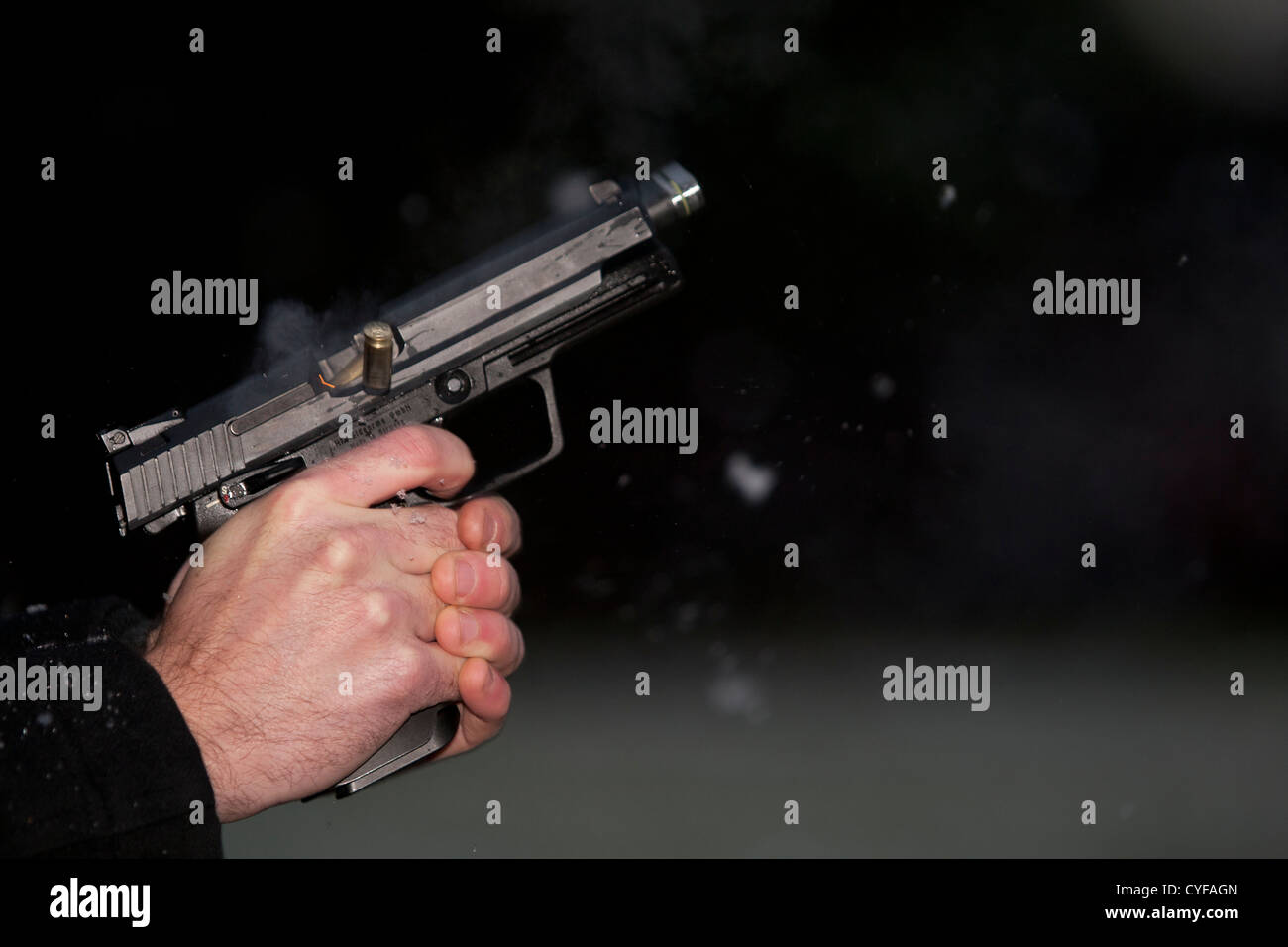 Shoots with gun close up Stock Photo - Alamy