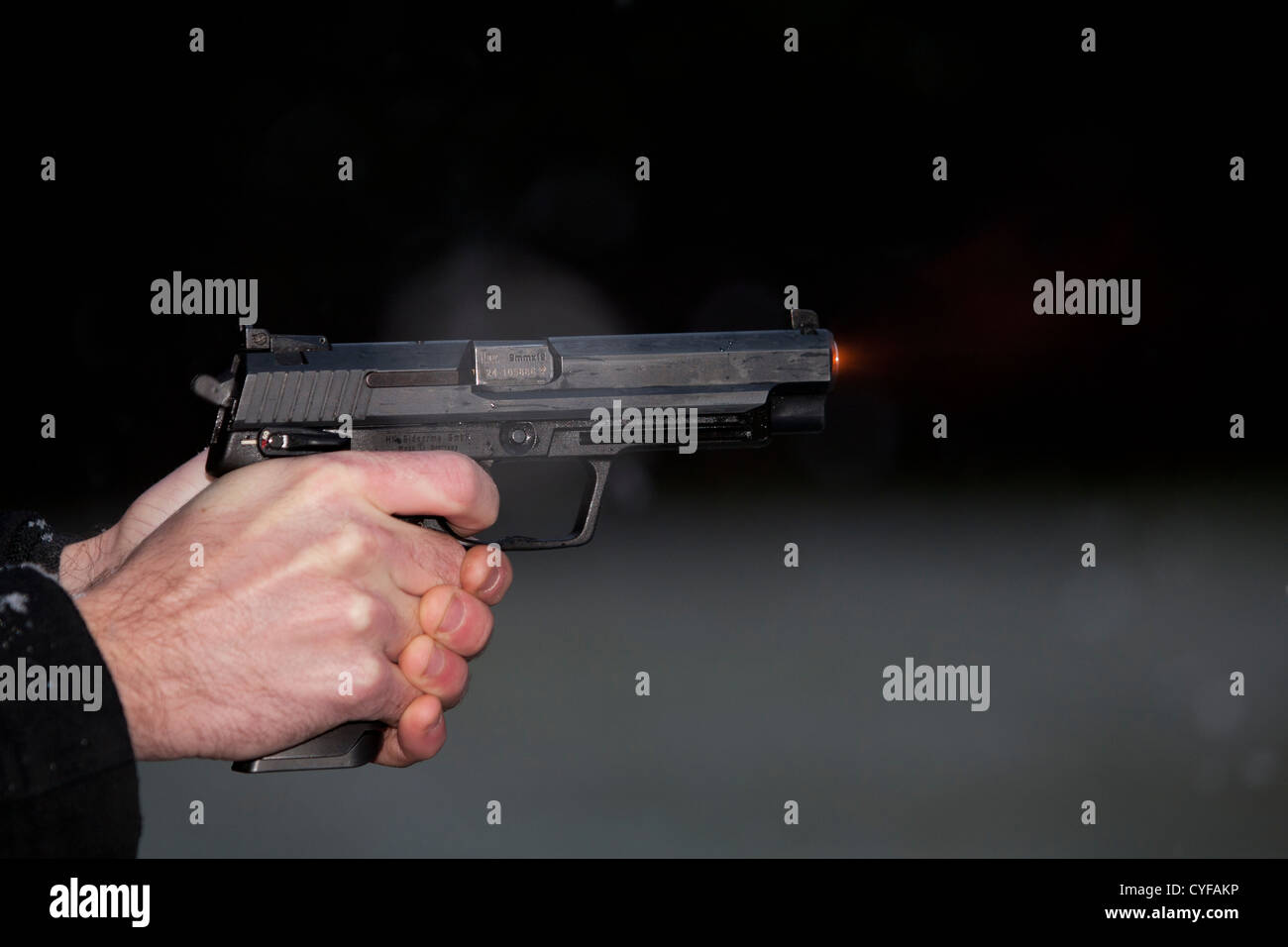 Shoots with gun close up Stock Photo - Alamy