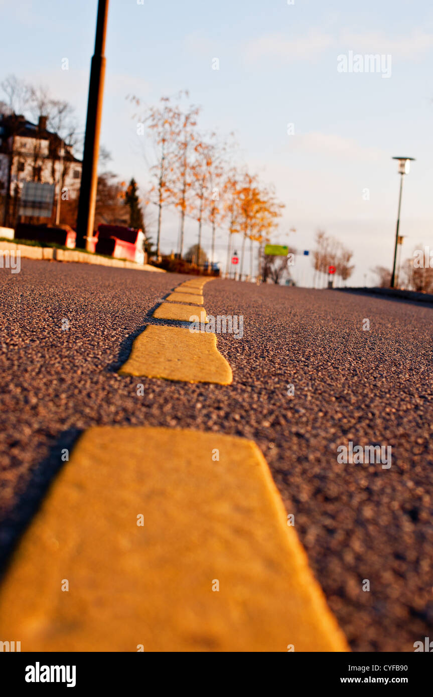 Yellow dividing line on asphalt road Stock Photo - Alamy
