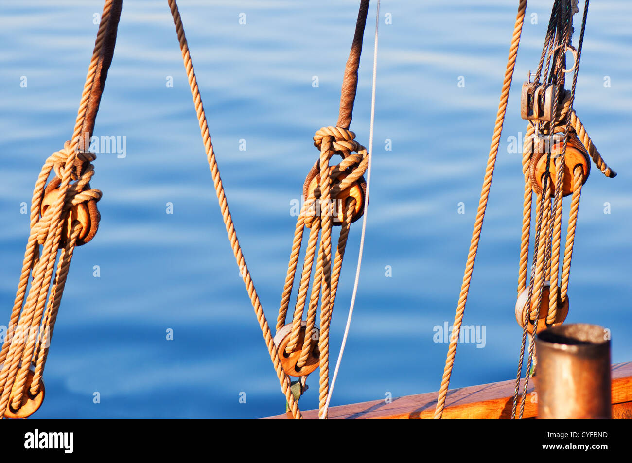 Sail yacht ropes and blocks on a water background Stock Photo - Alamy
