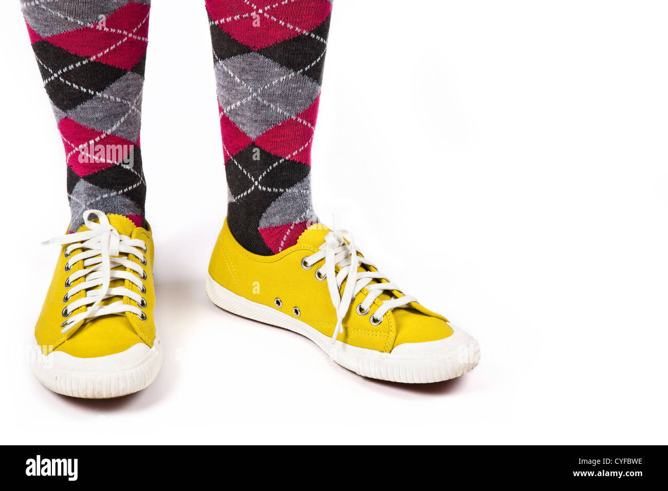 A flamboyant combination of flashy bright yellow sneakers paired up ...
