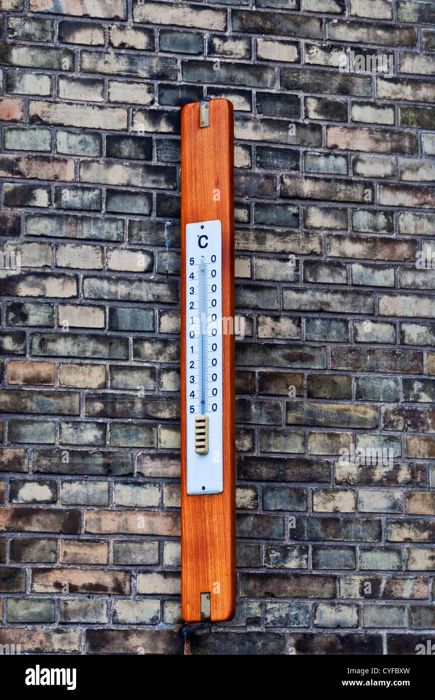 Outdoor thermometer on background brick wall Stock Photo - Alamy