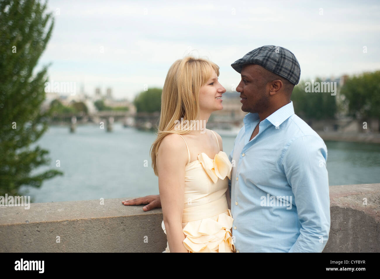 Paris, France - American mixed race young couple standing on abridge ...