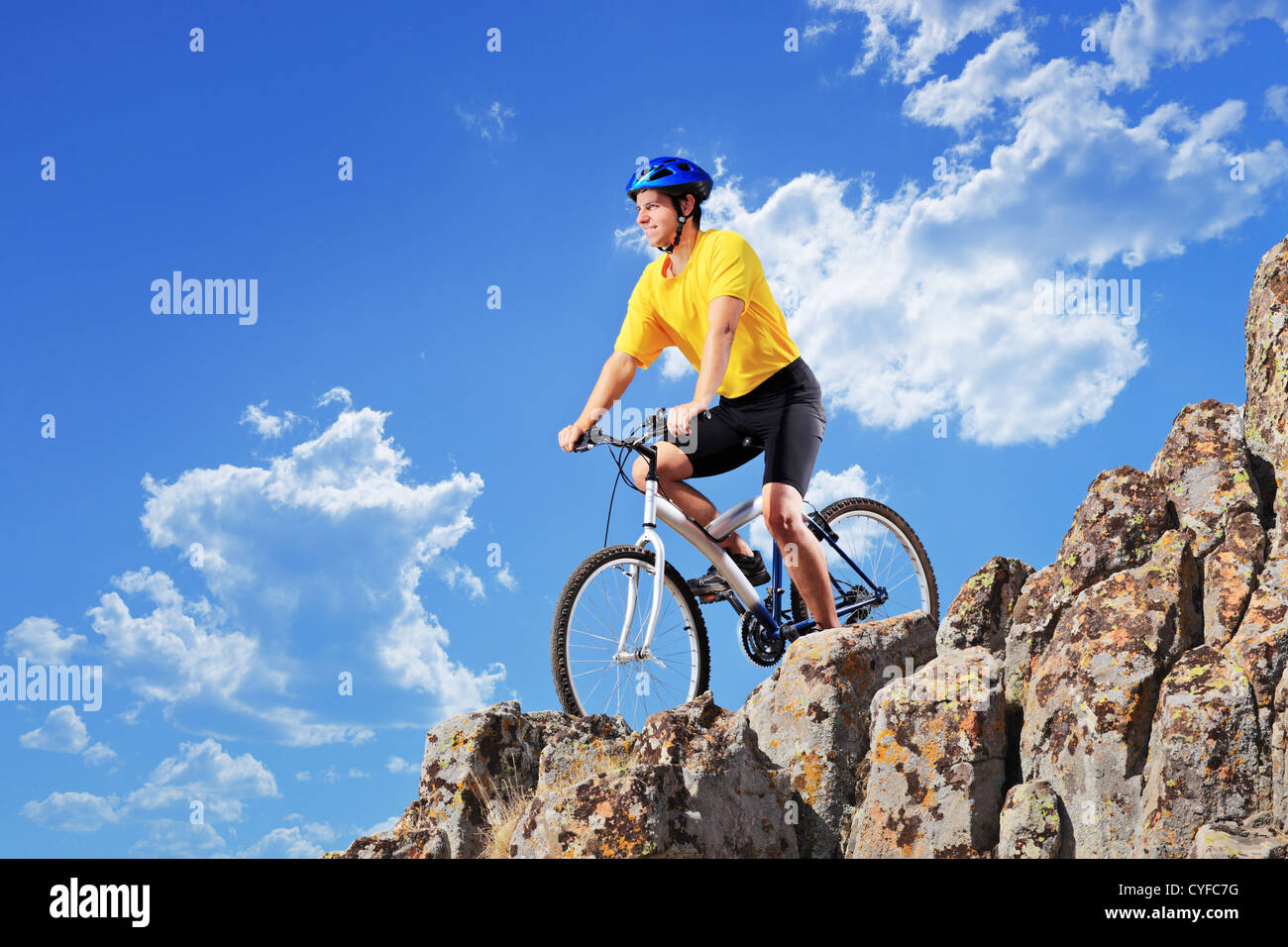 Biker riding a mountain bike on rocks Stock Photo - Alamy