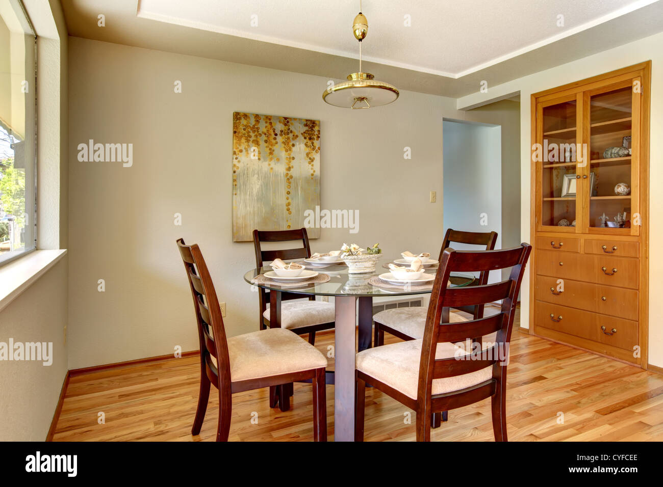 Dining room table with plates in a beautiful small room Stock Photo - Alamy