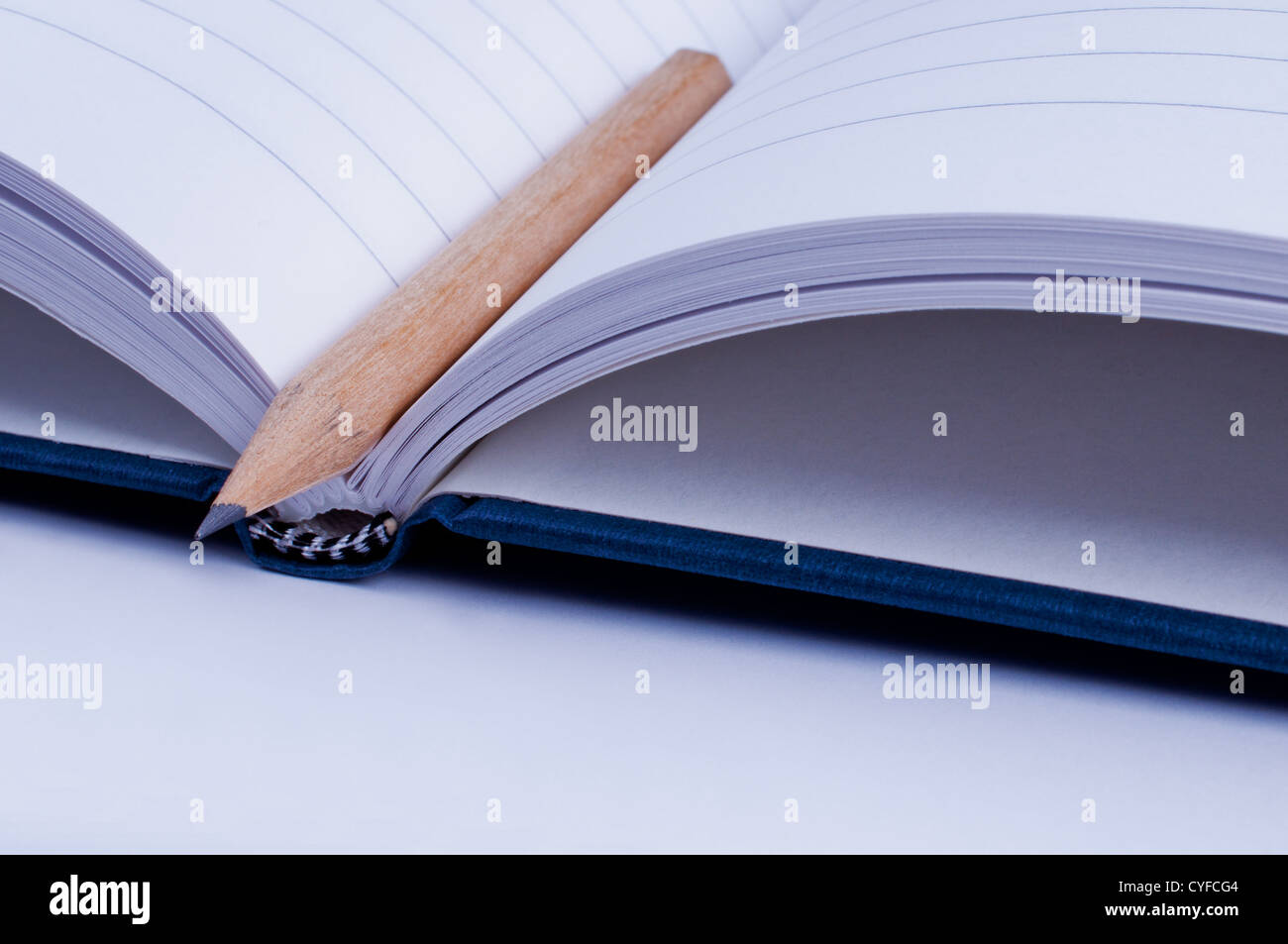 Open blue notebook with pencil close up Stock Photo - Alamy
