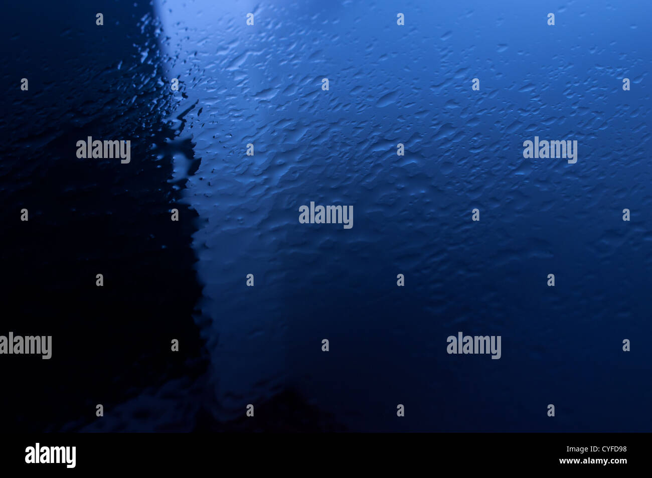 Spray water on a blue background close up Stock Photo - Alamy