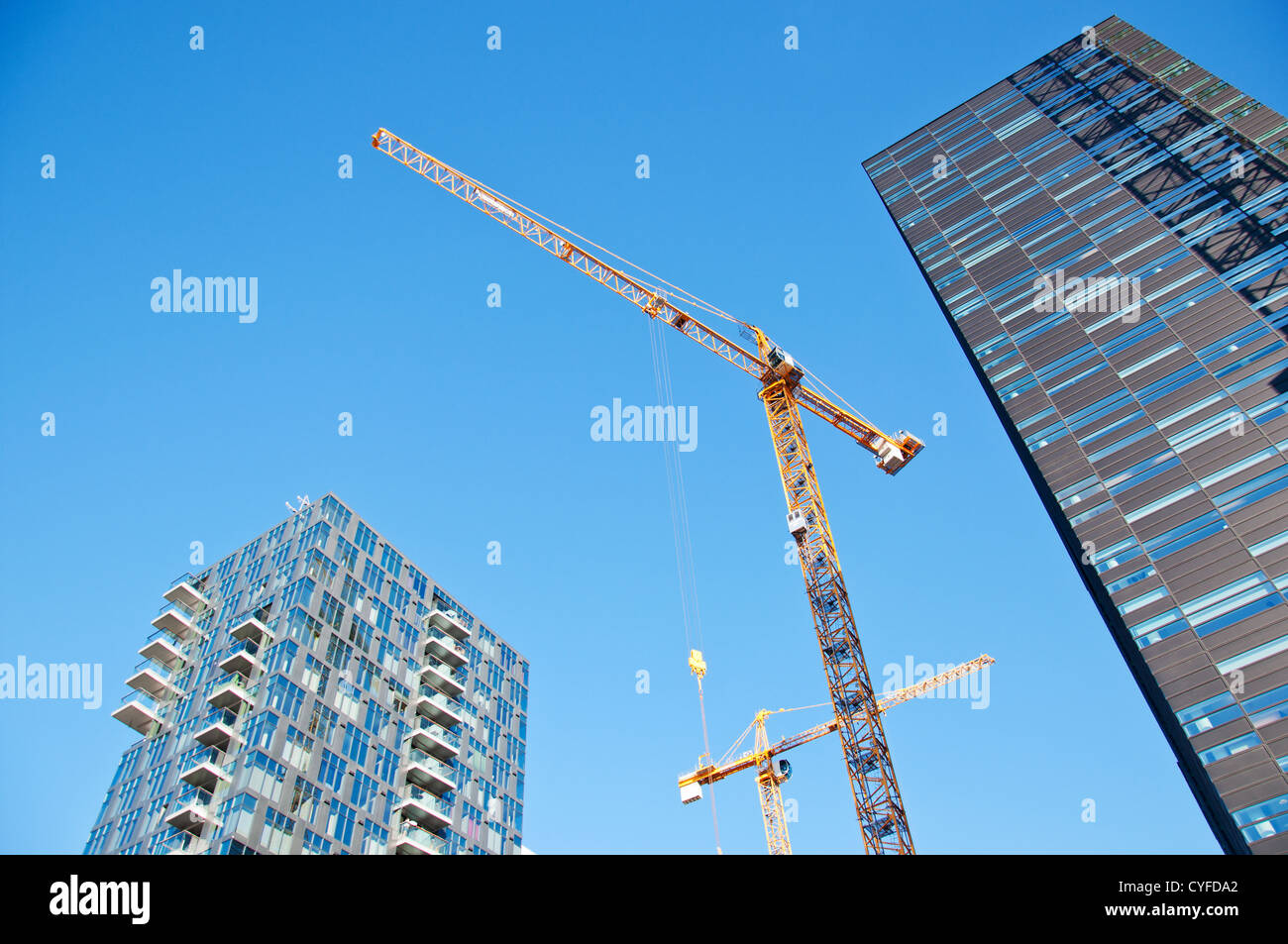 Skyscrapers with tower cranes on sky background Stock Photo - Alamy