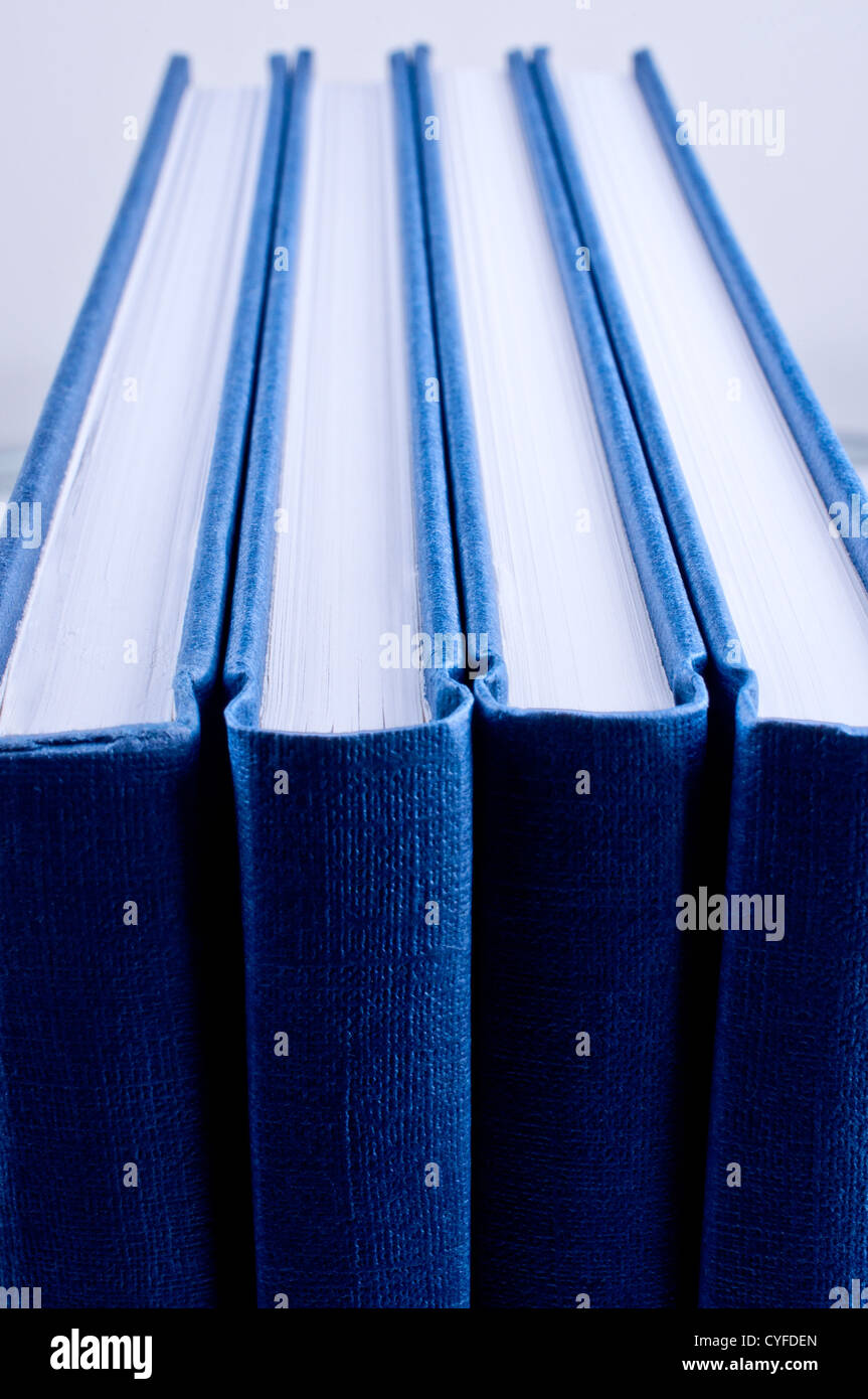 Four blue notepads isolated on white background Stock Photo - Alamy