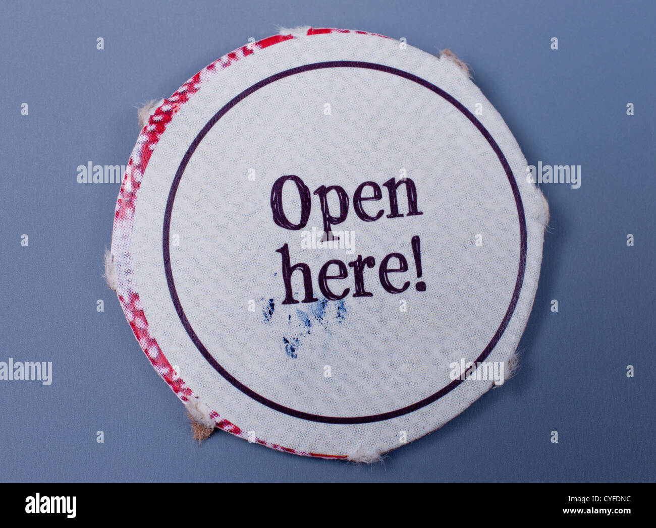 Open here wine box part close up on blue background Stock Photo - Alamy