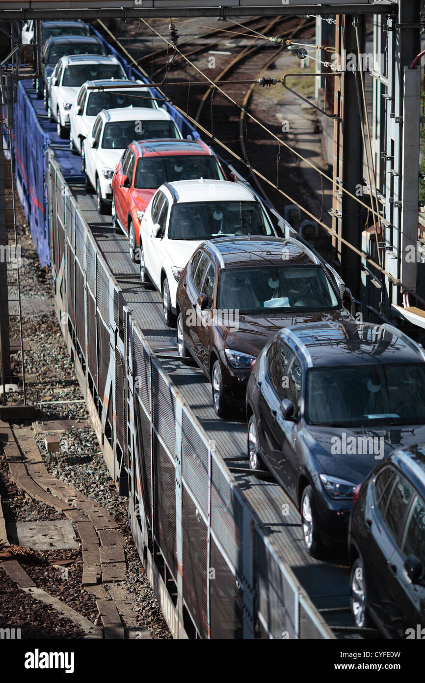 Cars being transported by rail Stock Photo - Alamy