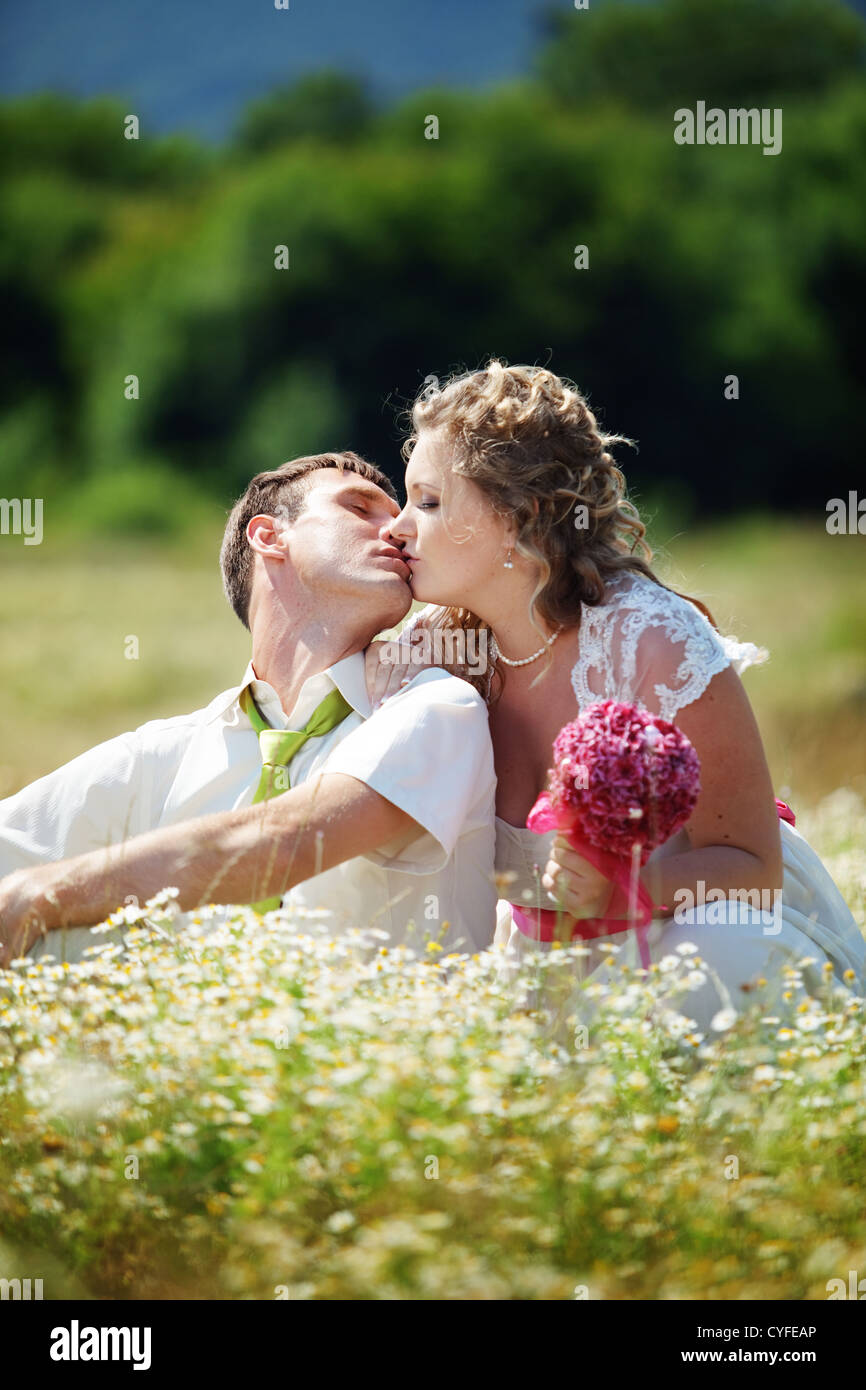 Wedding couple walking outdoor in field Stock Photo - Alamy