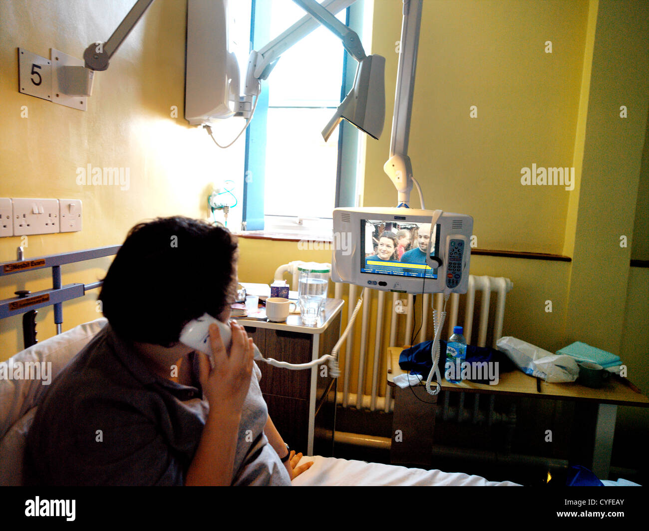 Patient Using Patient Line Phone and Television Unit in Hospital Stock ...