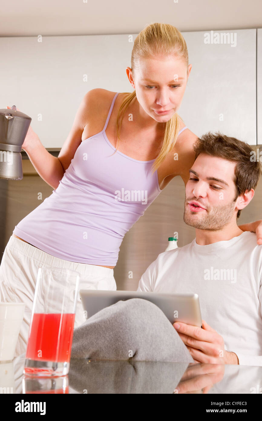 couple in kitchen having breakfast Stock Photo - Alamy