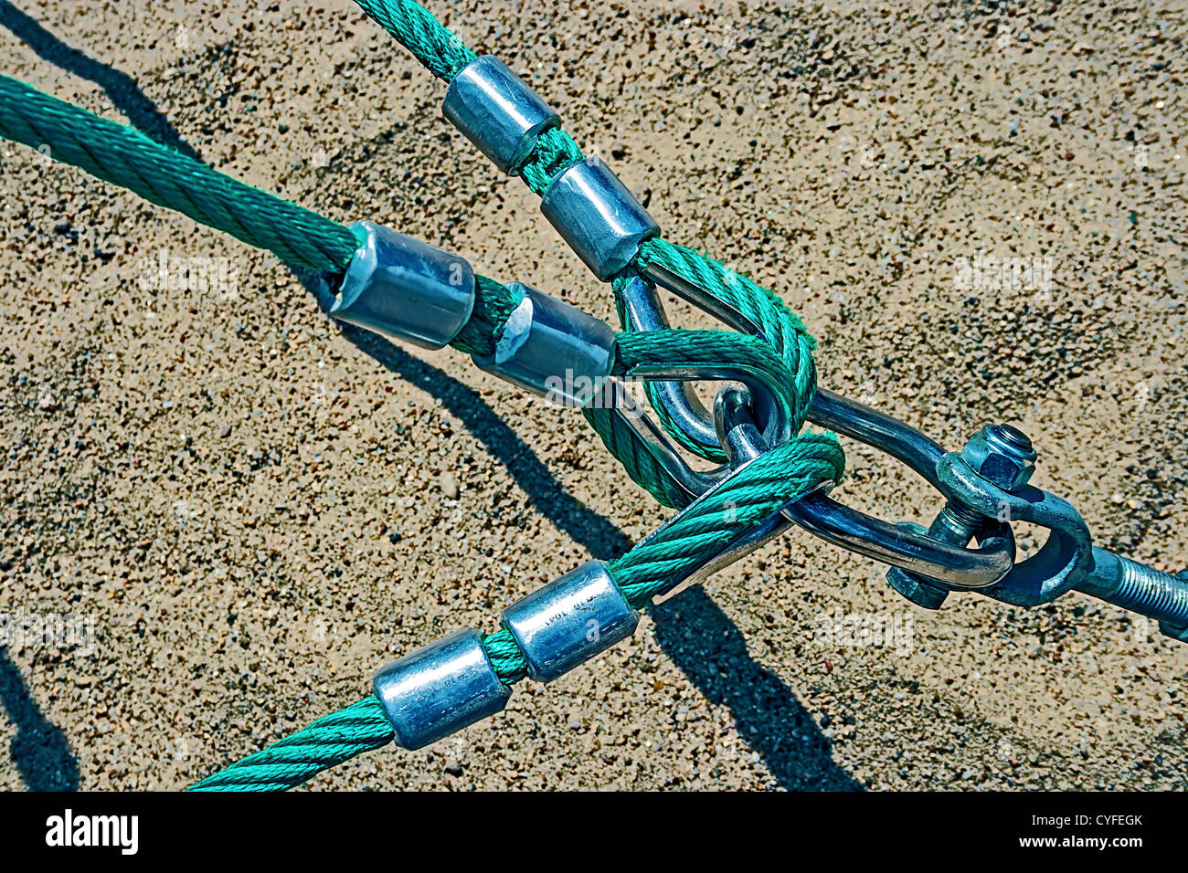 Colored ropes fastened together, on a sand playground for children ...